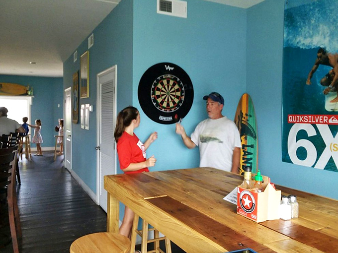 A friendly game of darts between bites&mdash;because at Twilley's, good food and good times are always on the same menu.