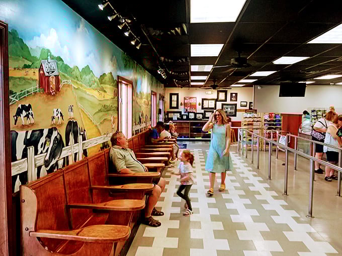 Three generations sharing one tradition. The mural's cows seem to nod approvingly at families continuing the sacred ritual of ice cream bonding.