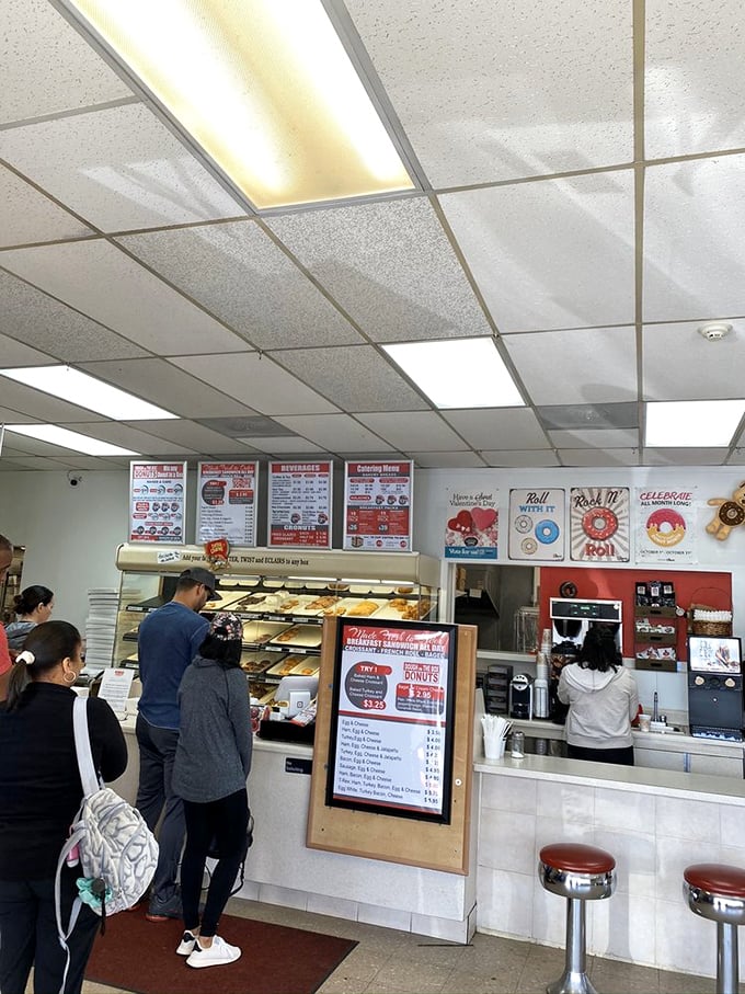 The morning pilgrimage in action. Like watching a delicious documentary unfold – anticipation, selection, and the promise of satisfaction.