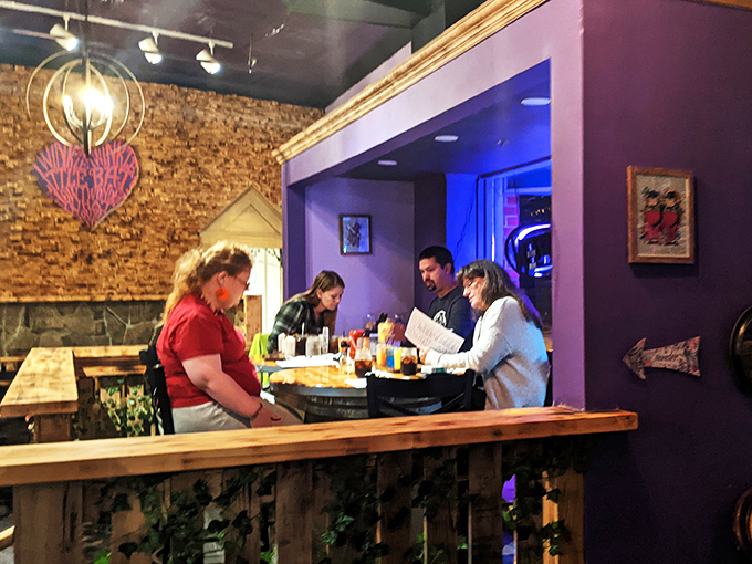 Diners huddle over menus in a purple-walled nook, contemplating which Wonderland creation will satisfy their curiosity and hunger in equal measure.