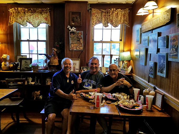 Three happy customers who've clearly discovered the secret to happiness: friends, barbecue, and a table big enough for all the sides.
