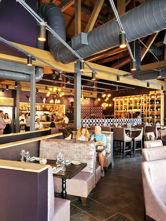 The spacious interior invites lingering, with exposed ductwork above and comfortable booths below. Dining at its most civilized without a hint of stuffiness.