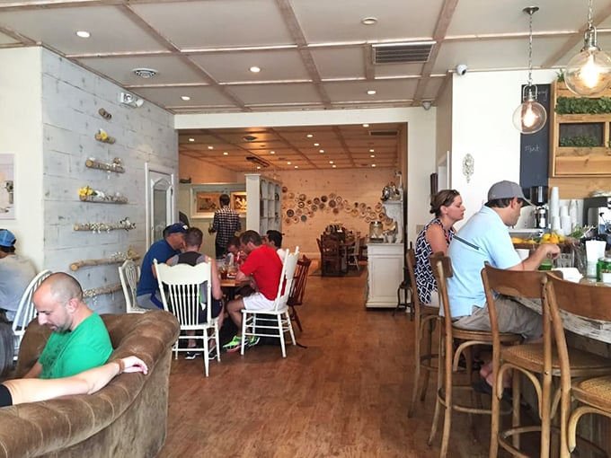 The leather Chesterfield sofa says "stay awhile" while the chalkboard menus remind you why you came. Comfort meets culinary adventure in one sunlit space.