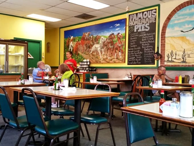 The chalkboard proudly announces "Famous Homemade Pies" while diners engage in that universally understood ritual of pretending to consider not ordering one.