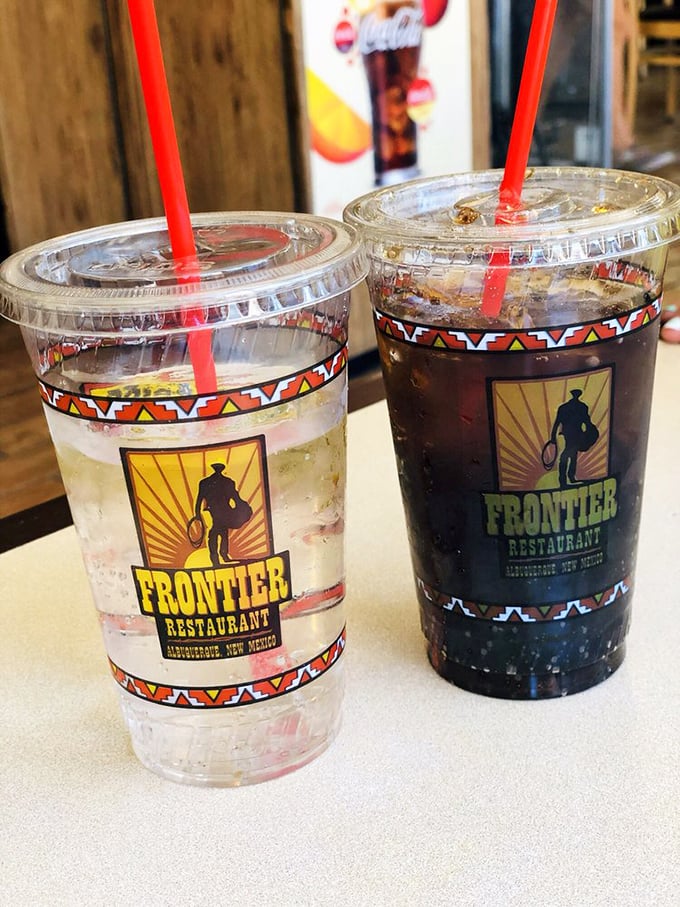 Soft drinks proudly wearing their Frontier insignia like vintage concert t-shirts—liquid companions to your chile-laden feast.