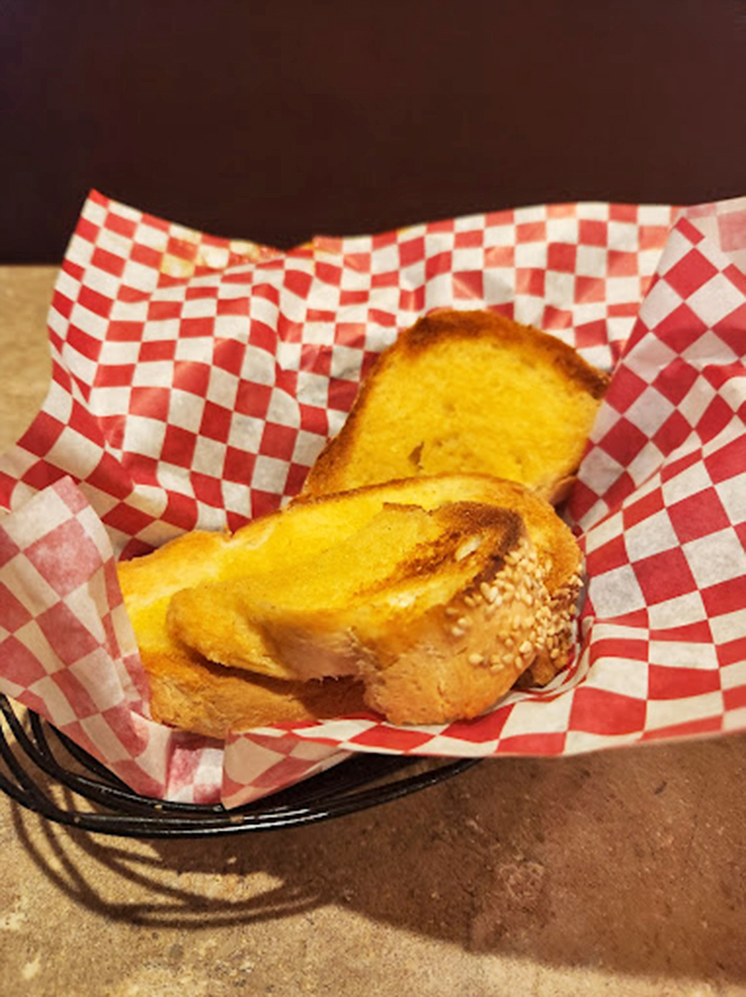 Garlic bread that's achieved the perfect golden hue. The checkered paper basket might as well be velvet—this is royalty in carbohydrate form.