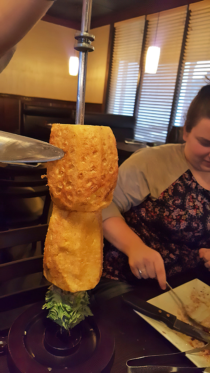 The grilled pineapple tower—part dessert, part spectacle, all delicious. It's the tropical exclamation point at the end of your meat sentence.