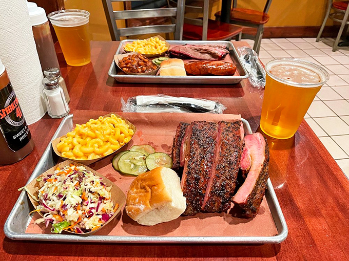 Two trays of barbecue bliss with craft beers standing by&mdash;proof that sometimes the best conversations happen over food that requires no words.