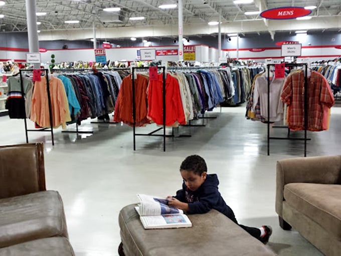 That young reader proves thrifting is multi-generational&mdash;homework between the men's shirts and furniture, because education waits for no bargain.