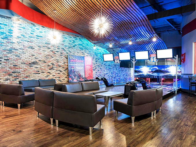 The lounge area blends industrial chic with racing flair&mdash;perfect for plotting your comeback while nursing both your beverage and wounded pride.