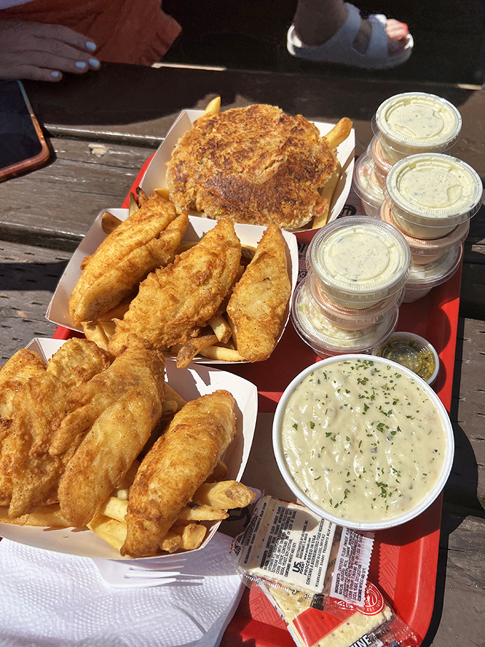 A seafood feast fit for Neptune himself. The crab cake commands attention, but those golden fish fillets are the unsung heroes of this spread.