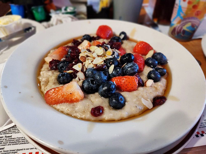 Morning meditation in a bowl: oatmeal adorned with nature's jewels &ndash; berries and nuts creating a breakfast both virtuous and indulgent.