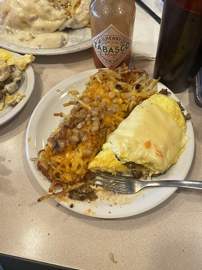 This isn't just an omelet&mdash;it's a cheese-draped love letter to morning hunger, with hash browns playing a delicious supporting role.