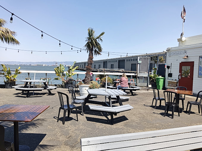 Palm trees, picnic tables, and panoramic bay views. The outdoor seating area doesn't just offer tables&mdash;it offers front-row tickets to San Francisco's daily water ballet.