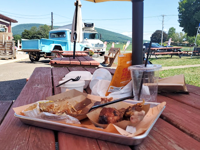 Rustic wooden beams and string lights create the perfect backdrop for serious meat appreciation. The American flag reminds you: barbecue is patriotic duty. 