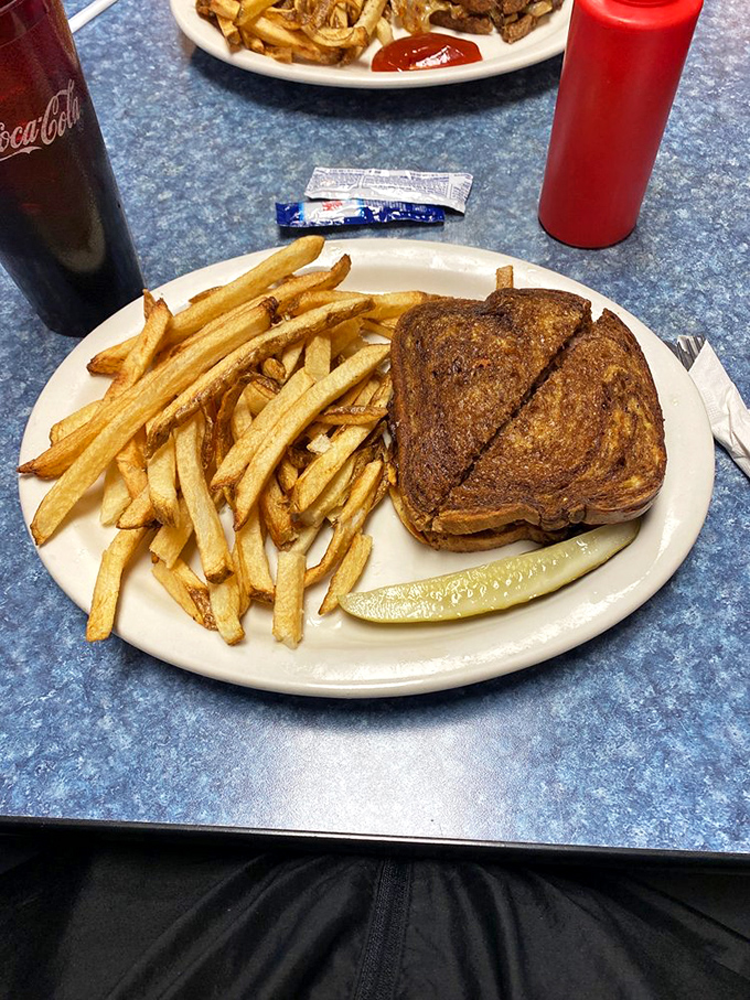 The patty melt—that rebellious sandwich that refused to choose between burger and grilled cheese, with fries as loyal sidekicks.