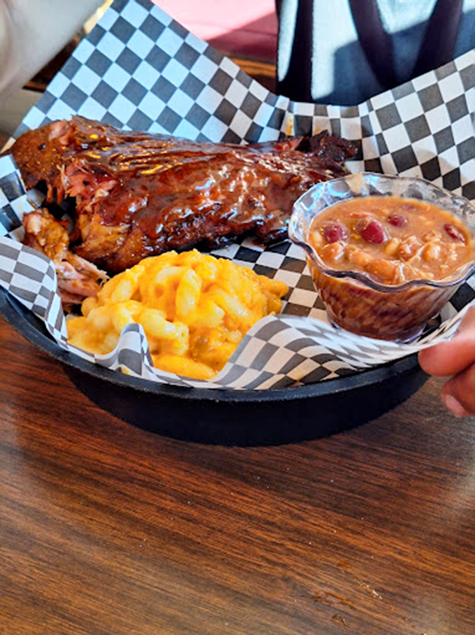 The holy trinity of barbecue perfection: fall-off-the-bone ribs, mac and cheese that's actually cheesy, and beans with substance.