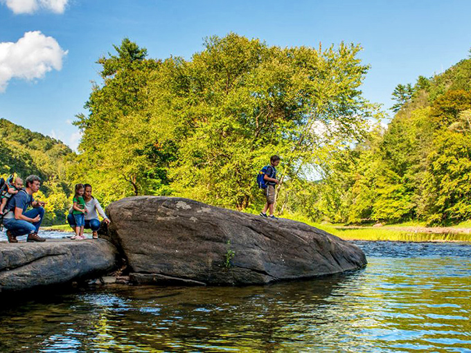 Nature's perfect playground where families create memories on sun-warmed rocks. The Greenbrier River flows like a liquid timeline through the region's natural splendor.