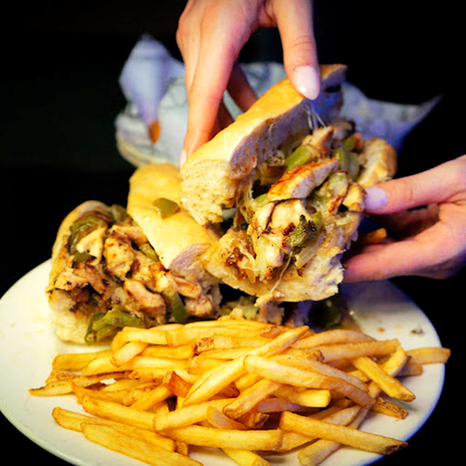 A sandwich that requires both hands and a strategy – layers of deliciousness threatening to escape with each magnificent bite.