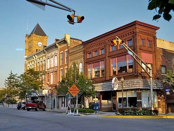 Sunset casts a warm glow across Bluffton's historic buildings, where brick facades have witnessed generations of small-town dreams unfold beneath that clock tower.