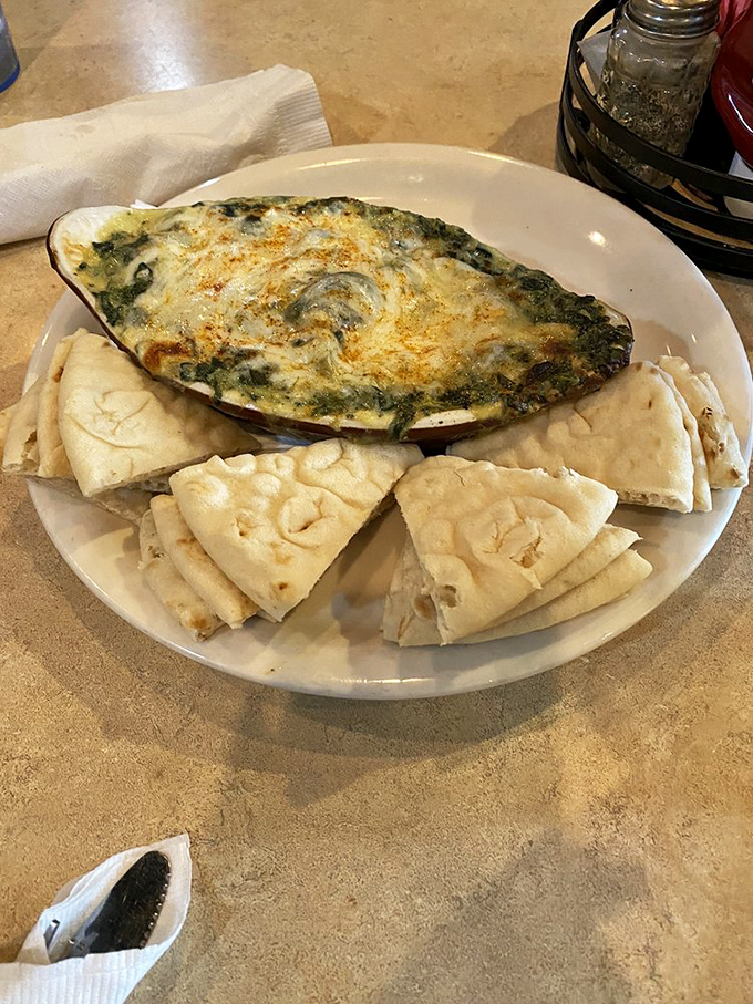 Spinach dip served with pita triangles&mdash;the vegetable dish that doesn't remind you it's a vegetable dish, which is the highest compliment possible.