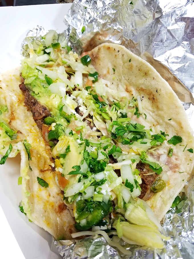 Freshly chopped lettuce and cilantro cascade over perfectly seasoned meat. This isn't just a burrito&mdash;it's edible art that happens to cure hunger pangs.
