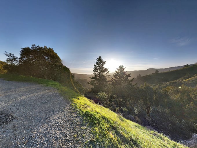 Golden hour transforms the hillsides into a painting so perfect you'd swear Bob Ross himself had a hand in designing this landscape.