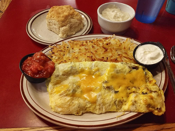 The breakfast menu board, framed by antlers, promises morning salvation with options ranging from "The Norm" to a 10 oz Ribeye for the truly ambitious.