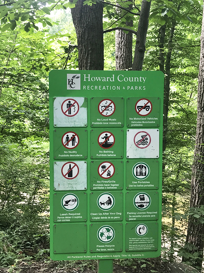 The rules board: where "No Littering" translates to "Don't mess with our little slice of paradise." Mother Nature's house, Mother Nature's rules.