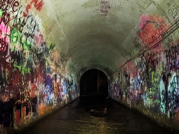 Flashlights reveal what daylight conceals. The tunnel's true character emerges when darkness falls and shadows play tricks on even the most rational minds.