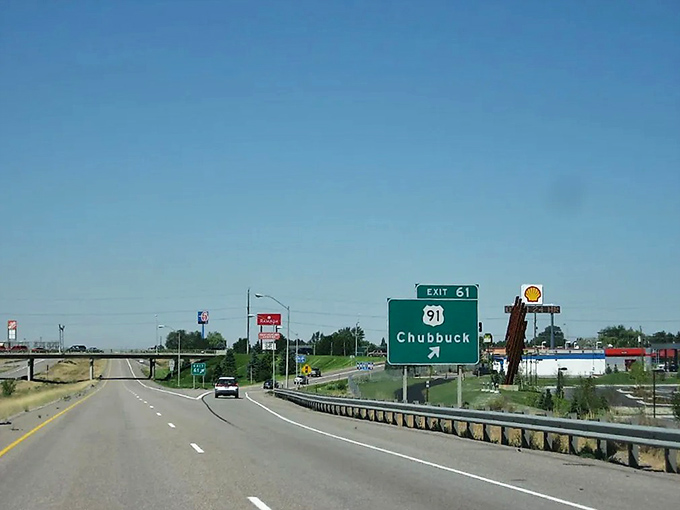 Chubbuck's highway exit sign promises affordable living with a side of "I know a shortcut" that locals will never share with outsiders.