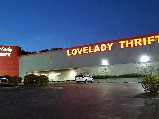 As night falls, Lovelady Thrift Store's illuminated signage serves as a beacon for after-hours bargain hunters with big dreams.