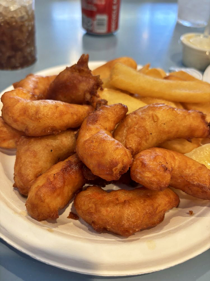 Golden-battered prawns that crunch like autumn leaves but taste like summer vacation. The kind of dish that demands you use all your fingers.