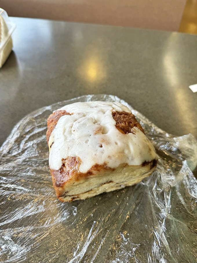 This isn't just a pastry - it's a cinnamon-swirled cloud with icing so perfect it belongs in the Museum of Comfort Foods.