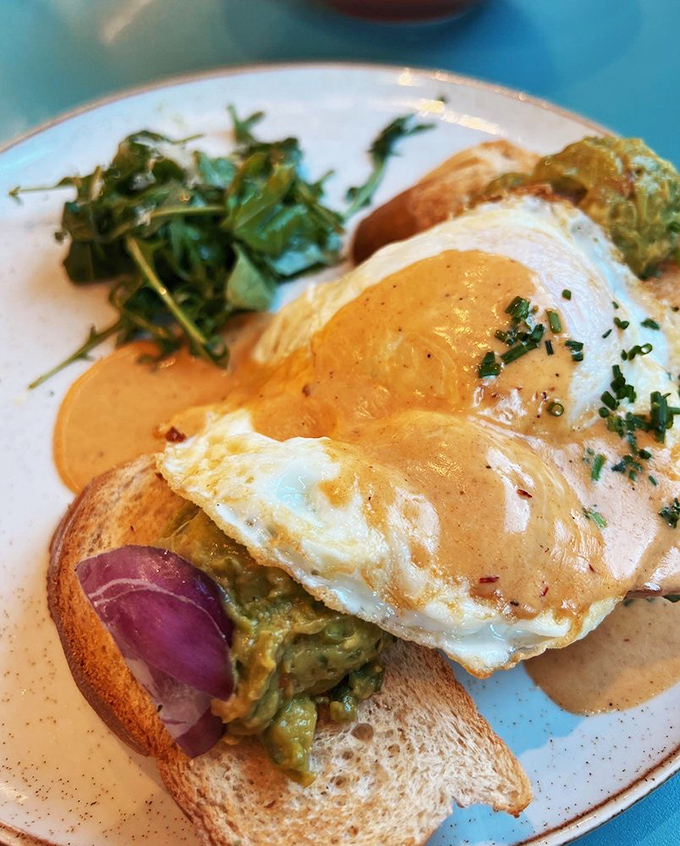 Avocado toast gets the royal treatment with a perfectly fried egg crown and a drizzle of hollandaise that's basically breakfast royalty.