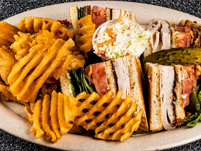 The club sandwich: three layers of bread engineering holding together the perfect balance of turkey, bacon, and summer tomato.