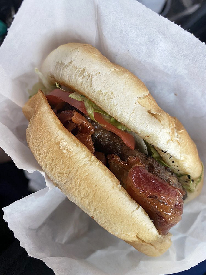 This bacon cheeseburger isn't just wrapped in paper&mdash;it's wrapped in anticipation. Every layer visible like delicious geological strata of flavor.