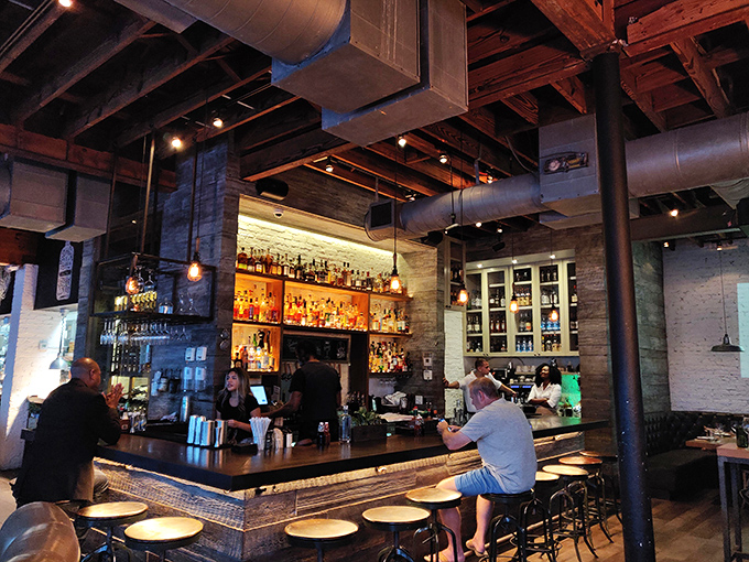 The bar glows like a bourbon-fueled beacon of hospitality. Where cocktail craftsmanship meets Southern charm in liquid form.