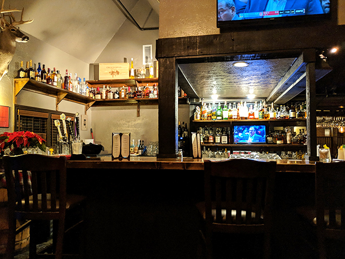 The bar at Fred's isn't just stocked—it's curated, with bottles arranged like trophies commemorating victories in the art of hospitality.