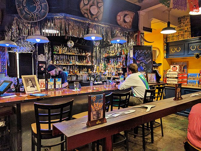 Silver tinsel and colorful lights transform a simple bar into something magical. Like Christmas came early, but brought tequila instead of presents.