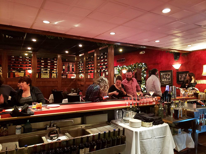 The bar area glows with holiday spirit and wine bottles standing at attention, ready for their moment to shine in your glass.