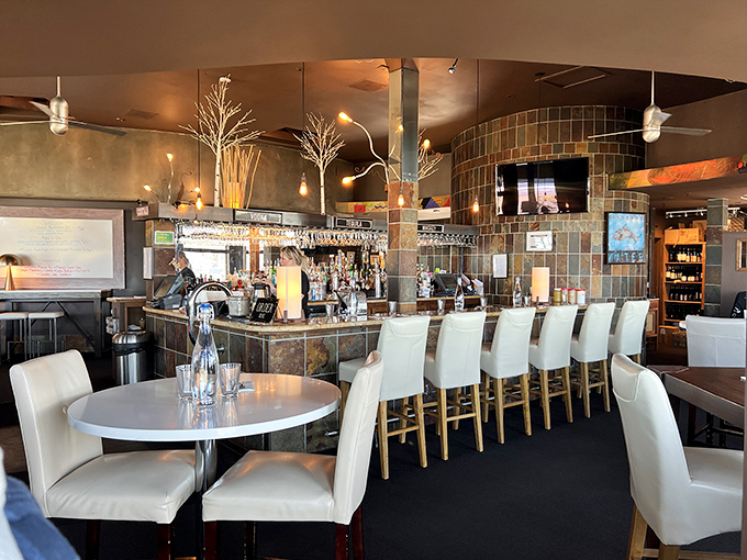 The bar area combines slate tiles and warm lighting to create a space where "just one drink" easily becomes "let's order appetizers too."