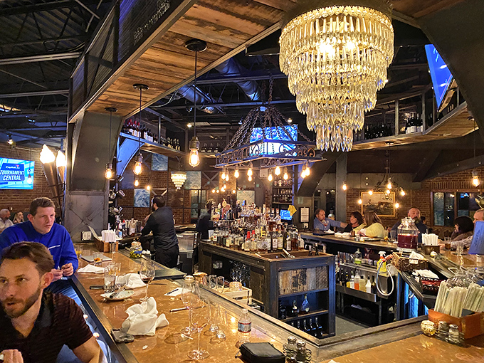 The bar gleams under crystal chandeliers like a bourbon-lover's fantasy come to life. Industrial chic meets Kentucky hospitality in perfect harmony.
