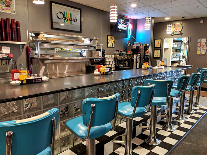 The counter seating offers front-row tickets to breakfast theater, with those turquoise chairs practically begging you to spin once when nobody's looking.
