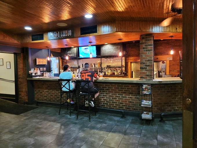 The bar area invites you to belly up and make new friends—because nothing bonds strangers faster than mutual appreciation for smoked meats.