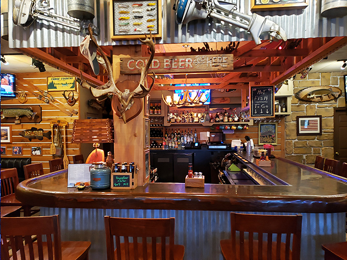 The bar area combines rustic charm with practicality – a perfect perch for solo diners or those waiting for the main event at their table.