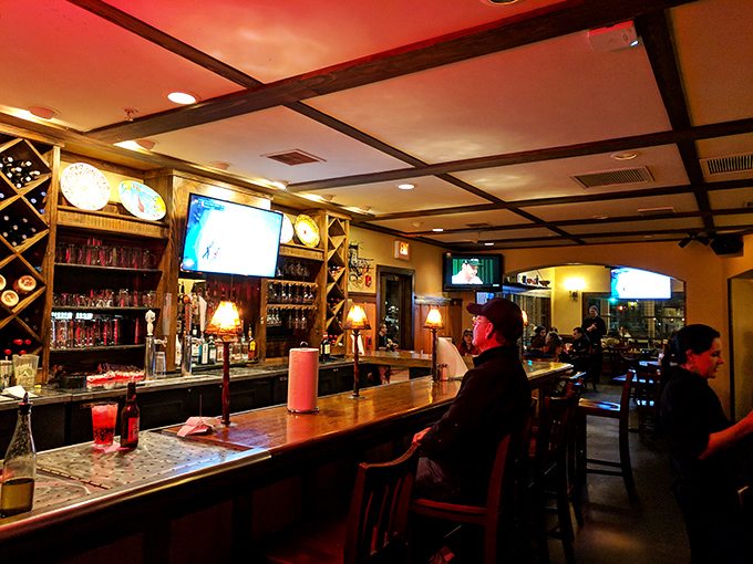 The bar area beckons with warm wood tones and ambient lighting that whispers, "That diet can start tomorrow. Tonight, we celebrate!"