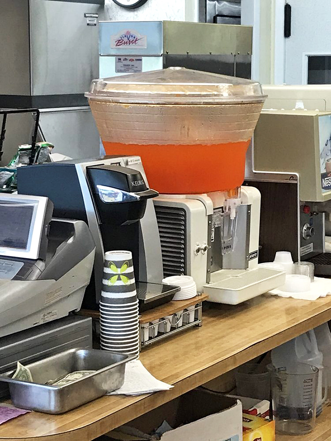 Three ice cream dispensers standing at attention like delicious soldiers, ready to serve up vanilla, black raspberry, and cherry happiness. 