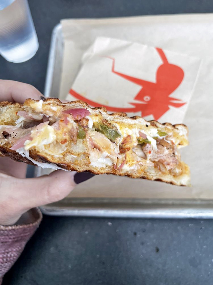 Cross-section perfection reveals the sandwich's secret life&mdash;layers of flavor conspiracies happening between two pieces of bread. Worth every napkin you'll need.