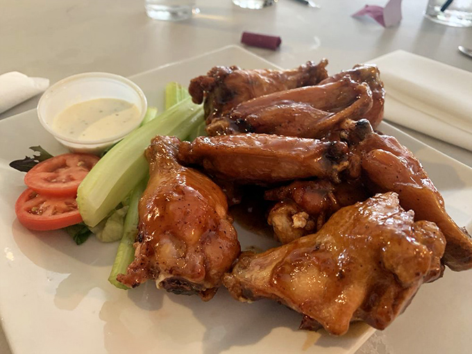 These chicken wings aren't messing around—glazed to perfection and served with the necessary cooling agents of vegetables and dipping sauce.